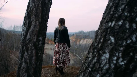 The young girl is turning back to the ca... | Stock Video | Pond5