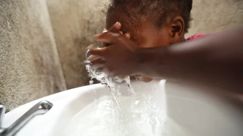 Young girl washing her face with clean w... | Stock Video | Pond5