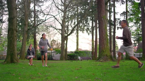 Young girls chasing down their father wi... | Stock Video | Pond5