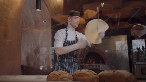 Young guy in chef uniform spinning and t... | Stock Video | Pond5