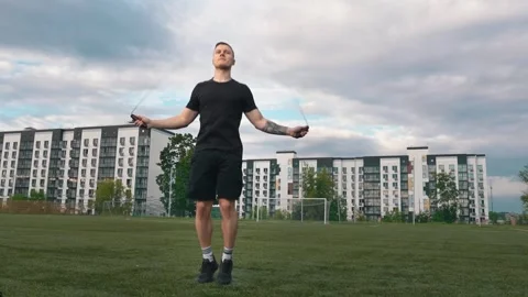 Young guy jumping rope on stadium | Stock Video | Pond5