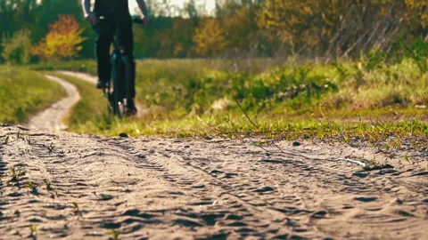 Young Guy Rides a Bicycle Along a Dusty ... | Stock Video | Pond5