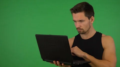 A young handsome athlete works on a note... | Stock Video | Pond5