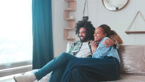 Young happy family man and woman sit hug... | Stock Video | Pond5