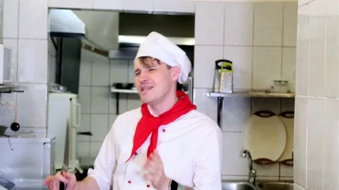 Young happy man dressed as chef with kni... | Stock Video | Pond5