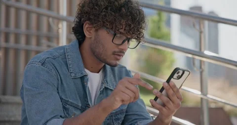 Young indian guy student holding mobile ... | Stock Video | Pond5