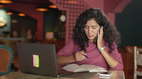 Young Indian woman busy over a phone cal... | Stock Video | Pond5