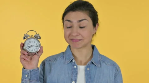 Young Indian Woman Holding a Clock, Yell... | Stock Video | Pond5