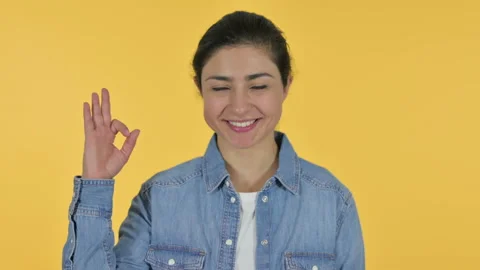 Young Indian Woman with OK Sign, Yellow ... | Stock Video | Pond5