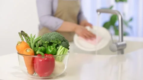 Young Japanese woman washing dishes in t... | Stock Video | Pond5
