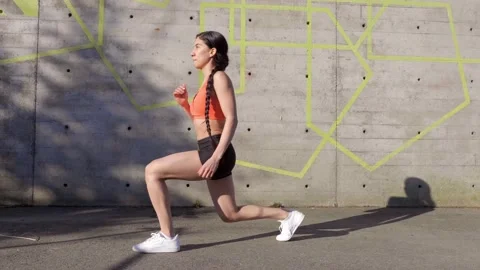 Young lean girl doing lunge exercise out... | Stock Video | Pond5