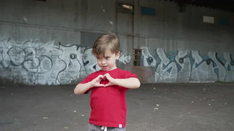 A young little boy is having fun and mak... | Stock Video | Pond5