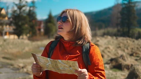 Young lost woman traveler with map and b... | Stock Video | Pond5
