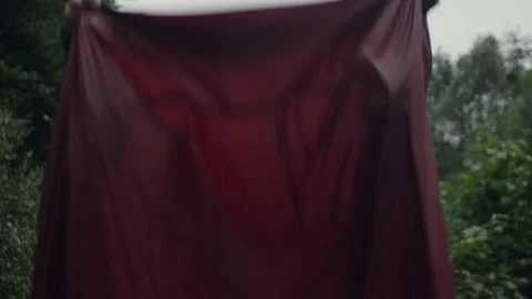 Young male shaking red tent in slow moti... | Stock Video | Pond5