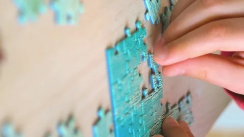 Young man assembling puzzle study comple... | Stock Video | Pond5