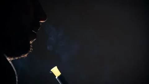 A young man in the backlight smokes a tr... | Stock Video | Pond5