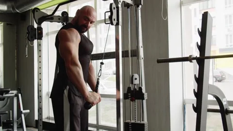 A young man bodybuilder in the gym train... | Stock Video | Pond5