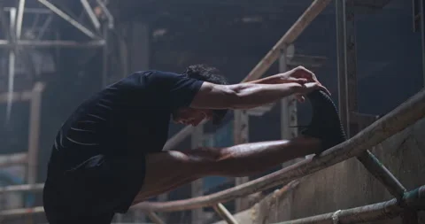 Young man boxer doing leg stretching exe... | Stock Video | Pond5