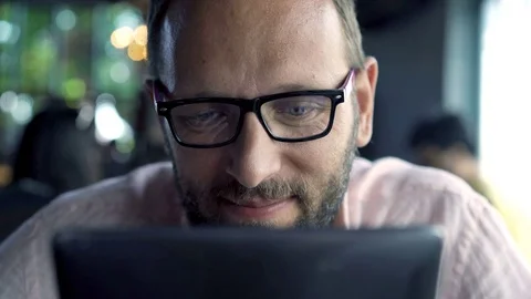 Young man browsing photos on tablet comp... | Stock Video | Pond5