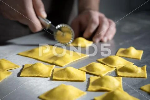Young Man Chef making ravioli pasta. Italian food home made pasta ...