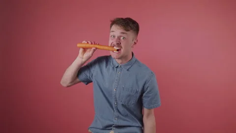 Young Man Chomping Down on a Carrot in F... | Stock Video | Pond5