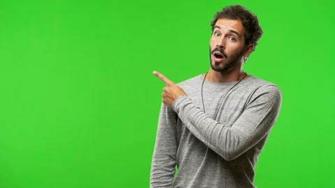 young man on chroma green screen pointin... | Stock Video | Pond5