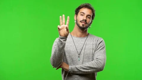 young man on chroma green screen showing... | Stock Video | Pond5