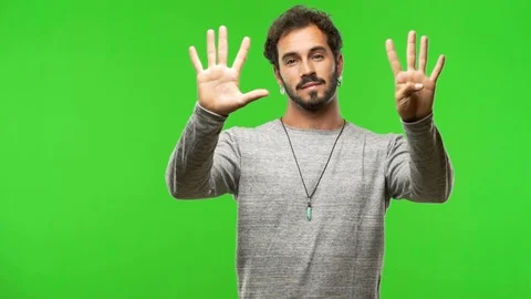 young man on chroma green screen showing... | Stock Video | Pond5