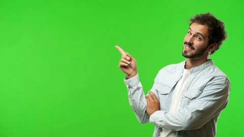 young man on chroma green screen pointin... | Stock Video | Pond5
