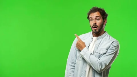 young man on chroma green screen pointin... | Stock Video | Pond5