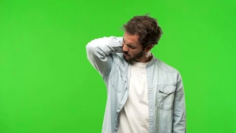 young man on chroma green screen sufferi... | Stock Video | Pond5