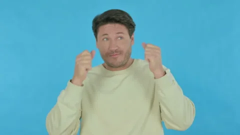 Young Man Dancing in Joy on Blue Backgro... | Stock Video | Pond5