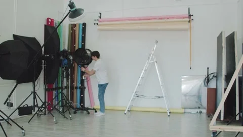 A young man in a design studio spreads t... | Stock Video | Pond5