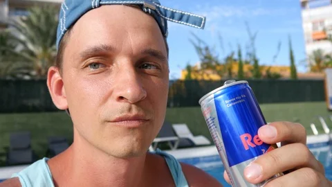 Young Man drinks Red Bull energy Drink, ... | Stock Video | Pond5