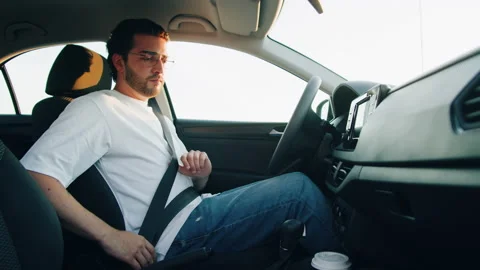 Young man driver close-up, using seat be... | Stock Video | Pond5