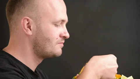 A young man is eating Mexican salsa chip... | Stock Video | Pond5