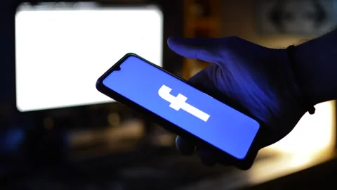 young man with facebook logo on his phon... | Stock Video | Pond5