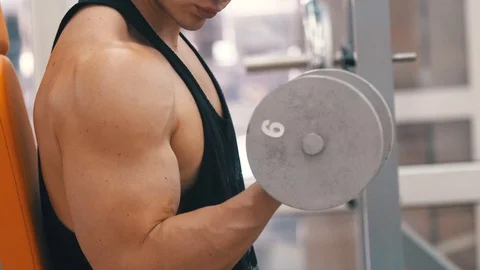 Young man hard training biceps muscles i... | Stock Video | Pond5