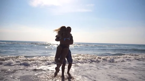 Young man hugging and spinning around hi... | Stock Video | Pond5