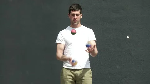 Young Man Juggling in Front of Concrete ... | Stock Video | Pond5