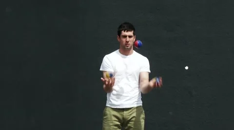Young Man Juggling in Front of Concrete ... | Stock Video | Pond5