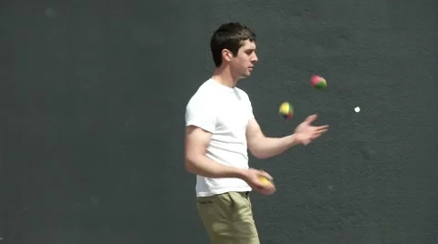 Young Man Juggling in Front of Concrete ... | Stock Video | Pond5