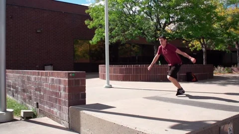 Young man jumping over a brick wall and ... | Stock Video | Pond5