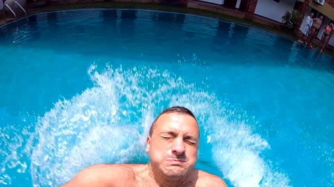 Young man jumping in pool with action ca... | Stock Video | Pond5