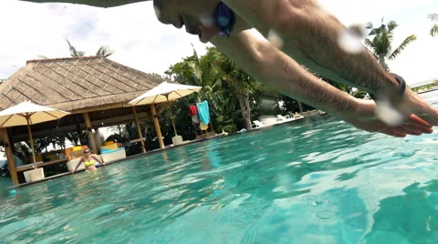Young man jumping into swimming pool, su... | Stock Video | Pond5