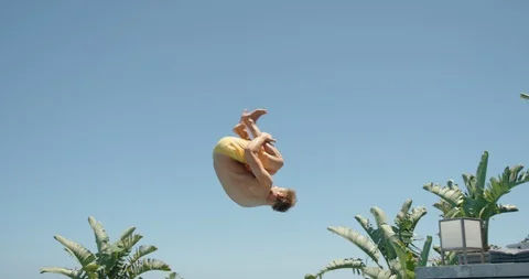 young man jumping in swimming pool in lu... | Stock Video | Pond5