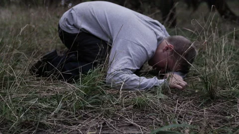 Young man lays on the ground crying and ... | Stock Video | Pond5