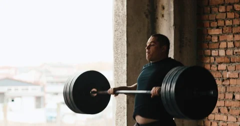Young man lifting heavy barbell. Army wo... | Stock Video | Pond5