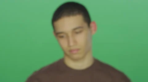 Young man looks sad, on a green screen b... | Stock Video | Pond5