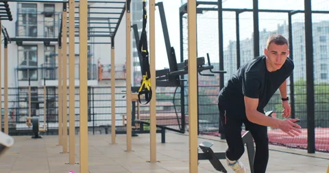Young man making jump exercise outdoors.... | Stock Video | Pond5